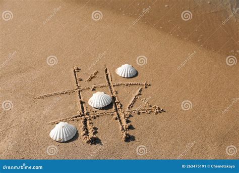Playing Tic Tac Toe Game With Shells On Sand Near Sea Space For Text