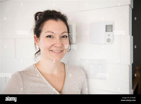A Woman Set The Thermostat At House Stock Photo Alamy