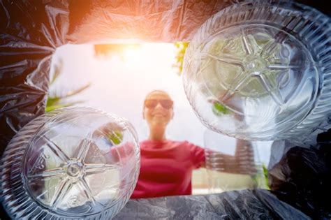 Premium Photo A Young Beautiful Girl Throws Sorted Garbage Into Special Bins