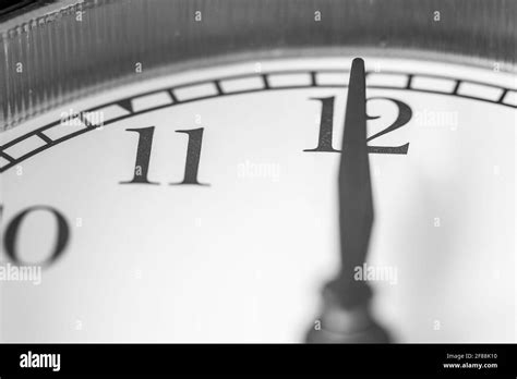 Clock Hand Pointing Twelve O Clock On White Clock Face Of Twin Bell Classic Alarm Clock Stock