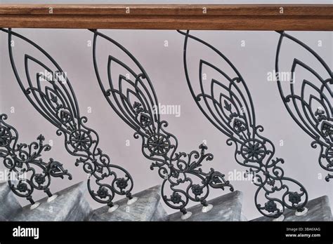 Close Up Of Elegant Wrought Iron Stair Railing With Intricate Floral