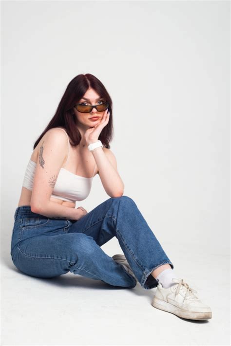 Girl With Brown Hair Posing In Bra And Unbuttoned Jeans On A Bed · Free