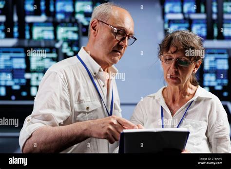 Senior Engineers Monitoring Data Center Rigs Optimizing Them For Data Processing Requirements