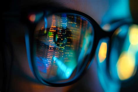 premium photo closeup of eyeglasses with a reflection of programming code