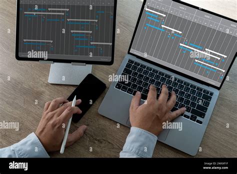 Business People Analyzing Project Management Updating Gantt Chart Stock