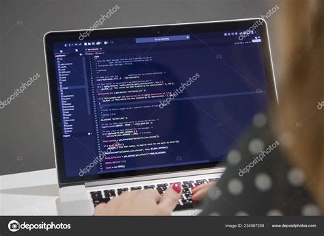 Woman Programmer With Cup Of Coffee Working On Laptop Computer In Office Stock Editorial Photo