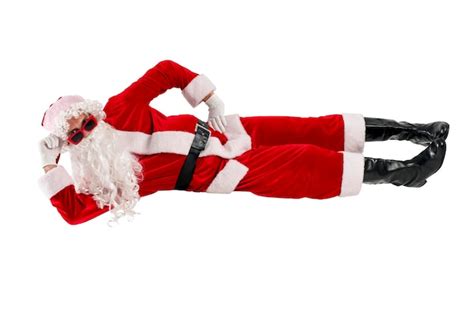 Premium Photo Lazy Santa Claus In Red Suit With Beard Rests And Lies In The Air And Levitates