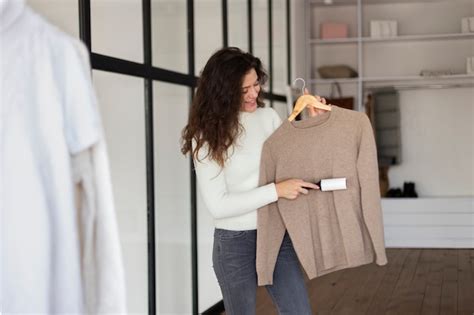 Free Photo Woman Removing Lint From Sweater
