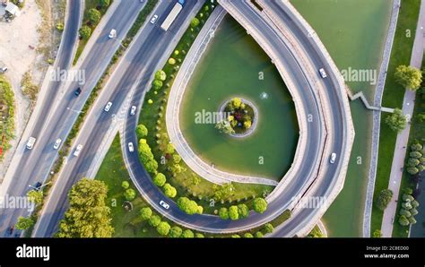 Aerial View Of The Roundabout On The River Trees Overpass Buildings And Vehicles Can Be Seen