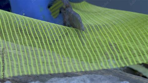 Contractor Cuts Fiberglass Reinforcing Plastering Grid Or Mesh On