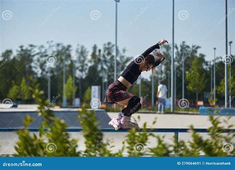 Young Roller Blader Female Grinding On A Rail In A Skatepark Cool