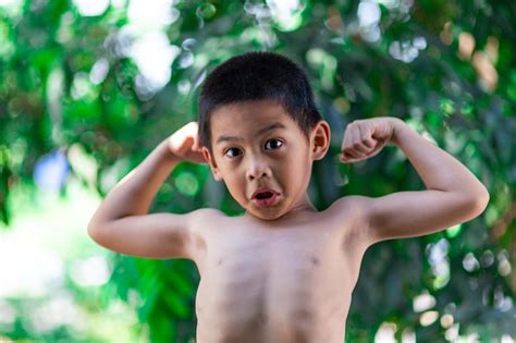 Premium Photo Shirtless Boy Flexing Muscles