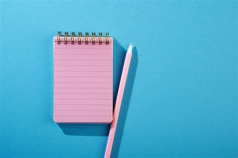 Premium Photo Single Lined Note Book And Pen On Blue Background