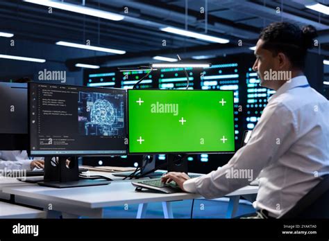 System Administrator Doing Checkup On Green Screen Computer In Server