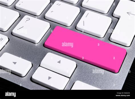 close up view of a computer notebook keyboard with one pink key