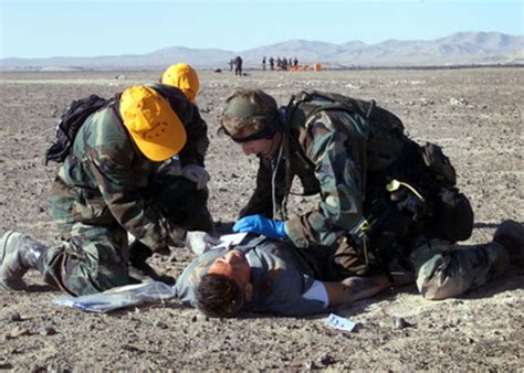 A Pararescueman And Two Members Of The Chilean Air Force Treat A Role