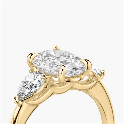 The Three Stone Oval Engagement Ring In Yellow Gold With A Plain Band