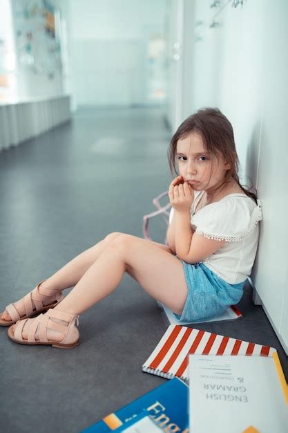 Premium Photo Girl Sitting On Floor Near Lockers After Fight With