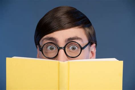 Nerd With Book Young Nerd Man Holding A Book On Head While Stan Stock