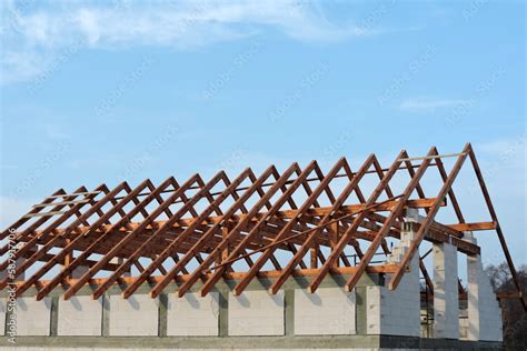 A Timber Roof Truss In A House Under Construction Walls Made Of Concrete Blocks Rough Window