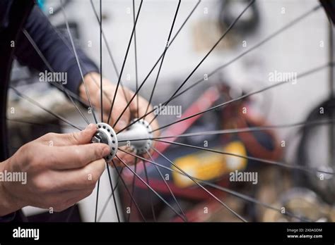 Unrecognizable Man Assembling A Bike Wheel Axle After Disassembling It For Cleaning And Greasing