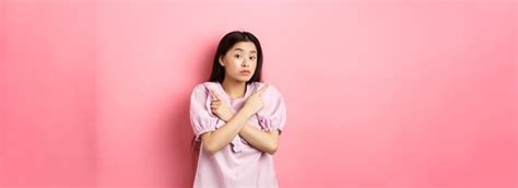 Free Photo Clueless Cute Asian Girl Pointing Sideways And Look