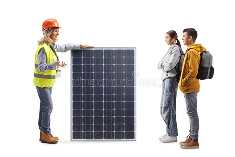 Female Engineer Talking To Students And Explaining A Solar Panel Stock