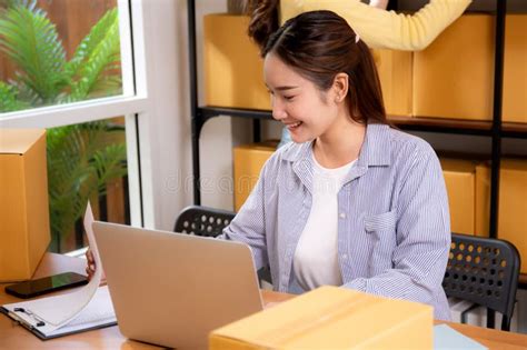Two Young Asian Businesswoman Checking Order Of Customer For Laptop Computer And Document