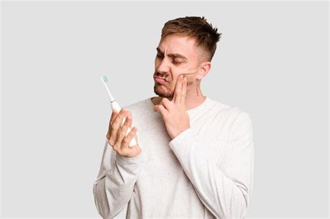 Premium Photo Young Man Using An Electric Toothbrush Cut Out Isolated
