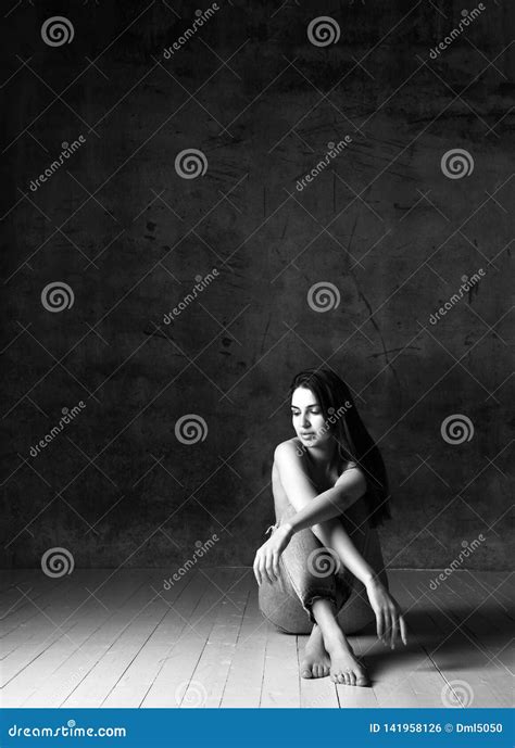Sensual Beautiful Woman Posing Naked In Jeans Sitting On A Floor With