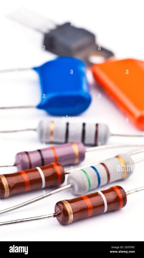 A Collection Of Resistors And Capacitors Arranged Neatly On A White Background The Components