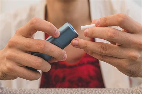 Premium Photo Smoker Smoking Hybrid Smokeless Cigarette Device That Uses Real Tobacco Refills