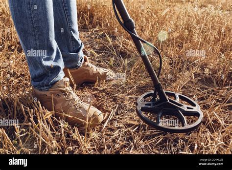 Man With Metal Detector Equipment Searching For Metal Goods In The Field Stock Photo Alamy
