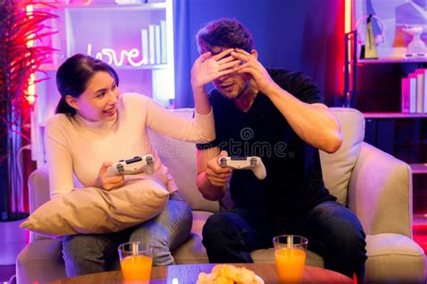 Couple Joyful Funny Playing Game Using Joysticks Trying To Disturb