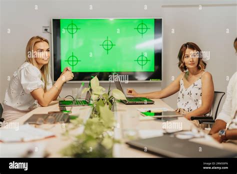 A Diverse Business Team Analyzing Statistics And Discussing Project Development In An Office