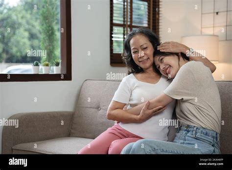 Smiling Grownup Daughter Hugging Older Mother Two Generations Concept