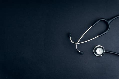 Premium Photo High Angle View Of Stethoscope On Table Against Black