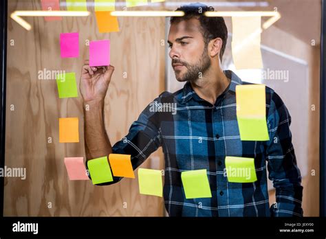Man Writing On Sticky Notes Stock Photo Alamy