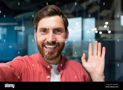 Young Happy Businessman Looking Into Smartphone Camera And Talking On
