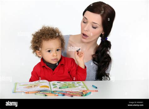 A Mother Teaching Her Son Stock Photo Alamy