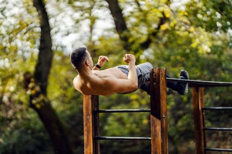 Premium Photo A Shirtless Sportsman Is Doing Exercises In Nature On