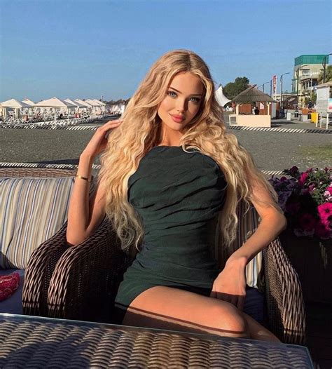 A Beautiful Woman Sitting On Top Of A Couch