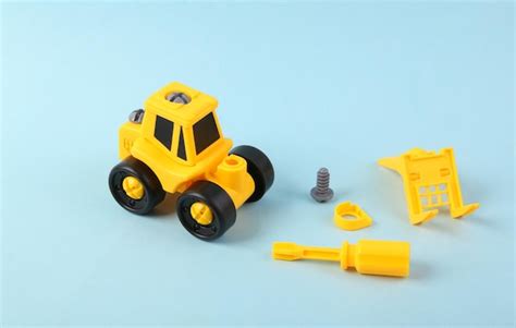 Premium Photo Disassembled Toy Loader On Blue Background Renovation Concept