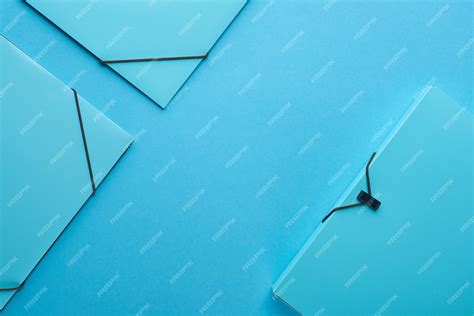 Premium Photo Top View Of Paper Binders Isolated On Blue With Copy Space