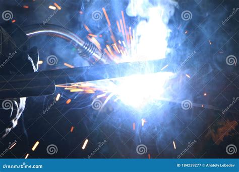 A Highly Skilled Welder Welds A Metal Structure At An Assembly Plant