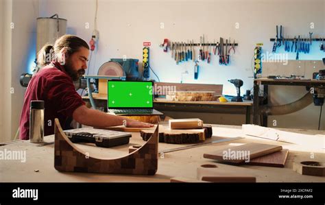 Upbeat Men Using Cad Software On Isolated Screen Laptop Debating Wood Design To Use Smiling