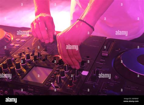 DJ Mixing Tracks On A Mixer In A Nightclub Stock Photo Alamy