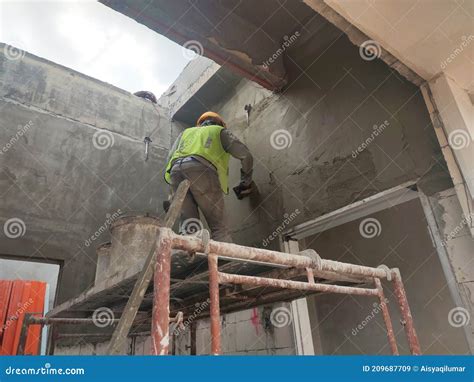 Plastering Work By Construction Workers Using The Cement Plaster