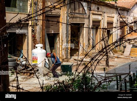 a man working in the buffer zone between the two sides of the divided