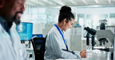 Science People And Communication With Microscope In Laboratory For